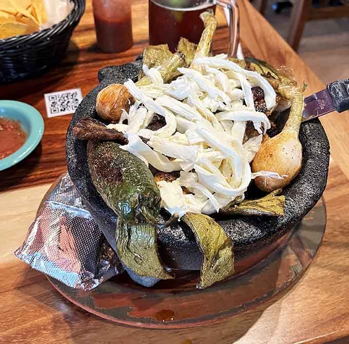 The molcajete arrives in a volcanic stone bowl that's hotter than Indiana in August, and twice as exciting.