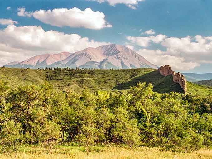 The Spanish Peaks rise from green valleys like nature's own monument to geological drama and patience.