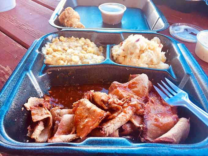 Brisket served on a blue cafeteria tray with sides&mdash;sometimes the best meals come without pretension or fancy plating.