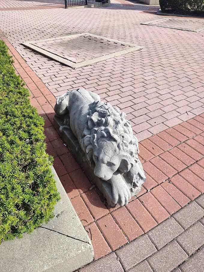 A stone lion guards the plaza, because every Italian landmark needs proper Mediterranean security.