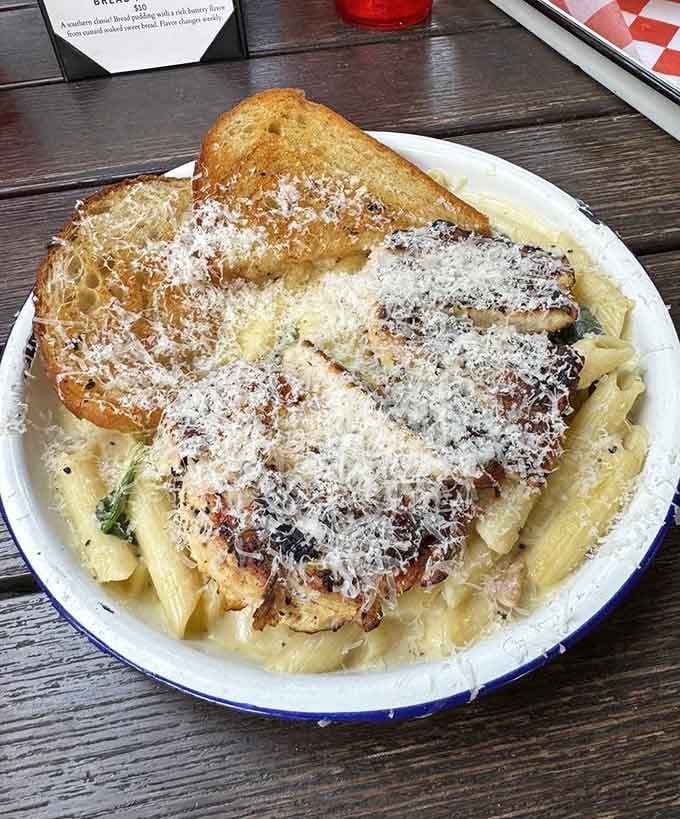 Penne pasta swimming in creamy sauce with grilled chicken, because sometimes Italian meets Southern and magic happens.