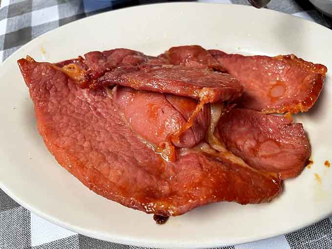 Country ham sliced thick and glazed just right, proving Kentucky knows exactly what it's doing with pork products.