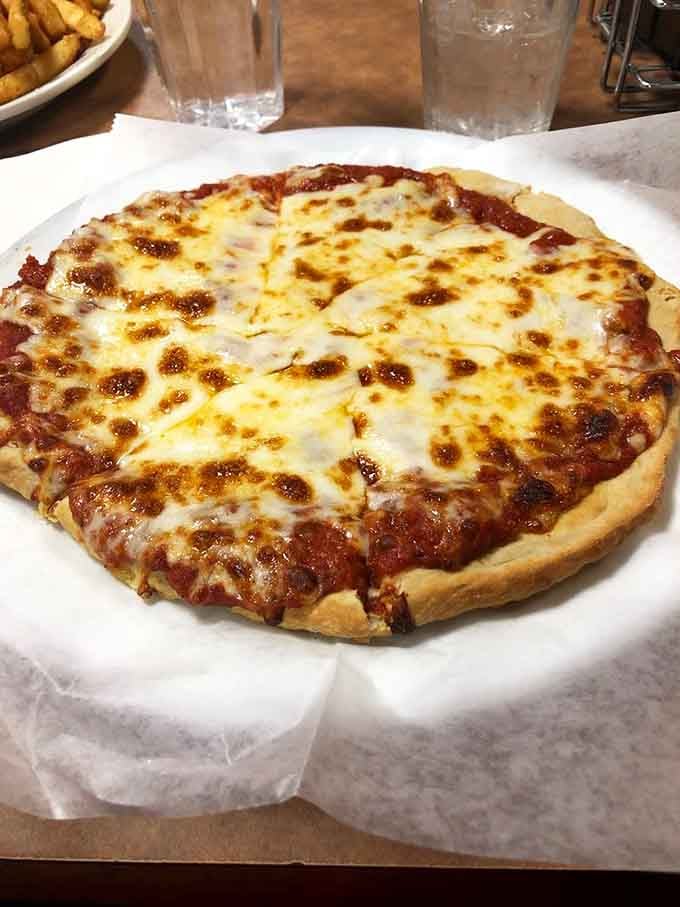 Personal pizza with cheese bubbling like a delicious science experiment you actually want to eat immediately.