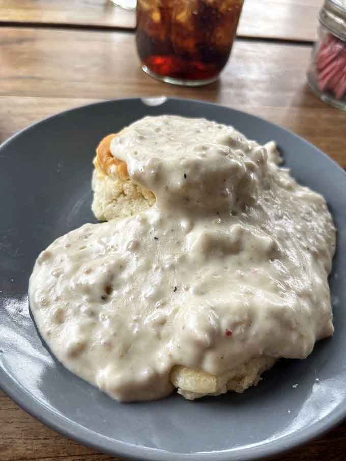 Biscuits drowning in sausage gravy, because sometimes more is more and restraint is highly overrated in breakfast.