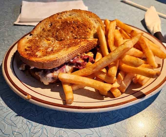 The patty melt oozing with melted cheese between toasted bread is pure diner perfection on a plate.