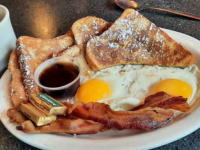 French toast dusted with powdered sugar alongside perfectly fried eggs: breakfast doesn't get more photogenic or delicious than this.