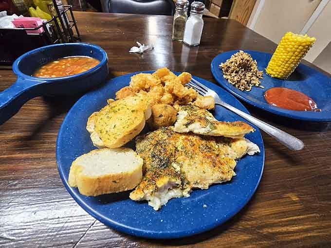 Fried catfish, garlic bread, black-eyed peas, and corn create the kind of plate that makes diets take a vacation.