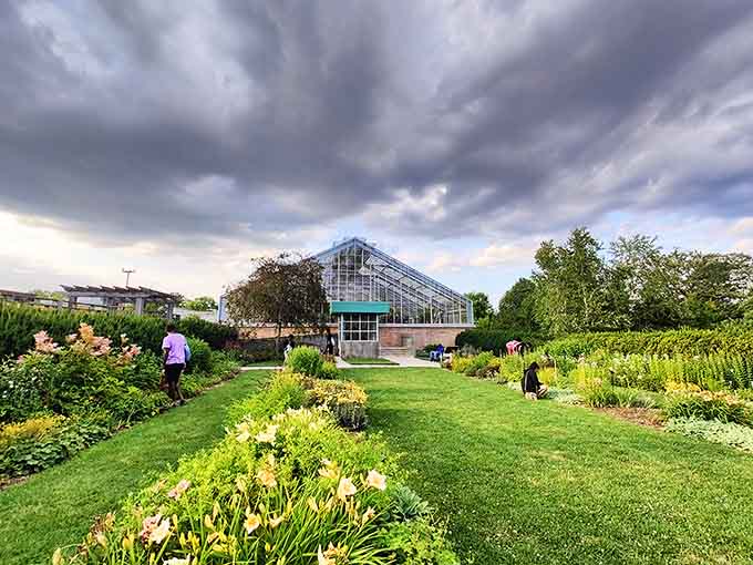 The conservatory rises behind gardens so perfectly maintained, your own yard might file for emancipation after seeing this.