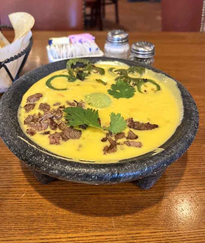 The legendary Bob Armstrong Dip in its traditional molcajete, layers of queso dreams that'll haunt you forever.