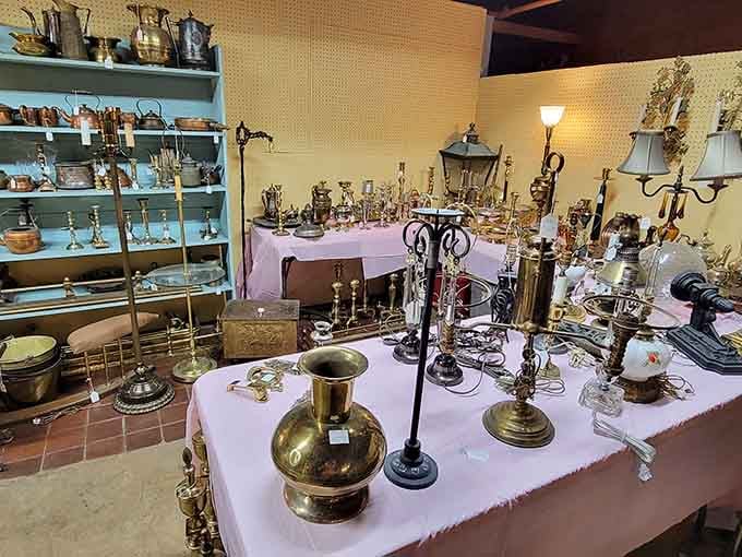 Brass vessels and candlesticks arranged like they're auditioning for a period drama set in someone's elegant parlor.