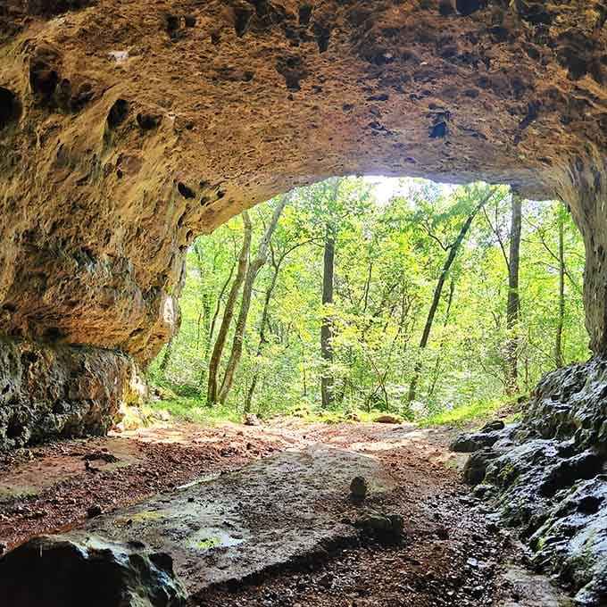Standing inside a natural cave opening feels like peeking through a window into another geological era entirely.
