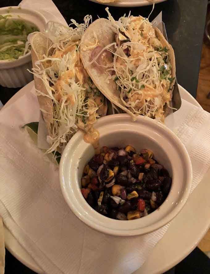 Crispy shells piled high with shredded cabbage and black bean salsa deliver taco perfection without any pretension whatsoever.