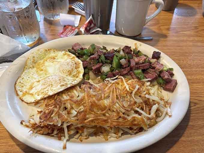Corned beef hash done right, topped with eggs and nestled beside hash browns that could make grown adults weep.