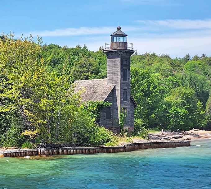 The East Channel Lighthouse guards the harbor like a wooden sentinel from Michigan's maritime past, still standing strong.