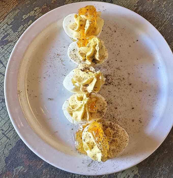 Deviled eggs lined up like little soldiers of deliciousness, ready to march straight into your heart.