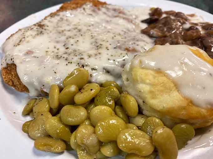 Country fried steak with creamy gravy, lima beans, and a biscuit&mdash;breakfast done right, Southern style all the way.