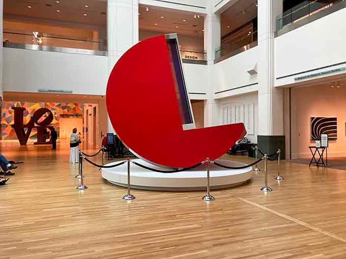 This massive red sculpture curves like a giant's smile, bold and unapologetic in its contemporary statement.