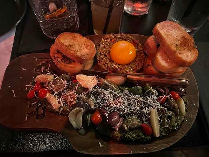 The Picada presentation includes perfectly toasted bread topped with steak tartare and a dramatic raw egg yolk.