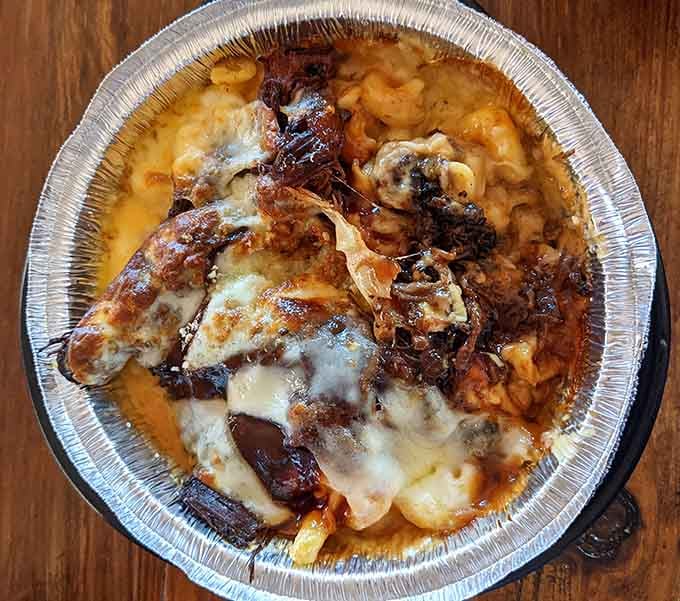 Mac and cheese topped with brisket in a skillet &ndash; because sometimes more is actually more, and that's perfectly okay.