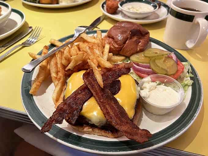 This cheeseburger with bacon and fries represents everything right about American diner culture in one glorious plate.