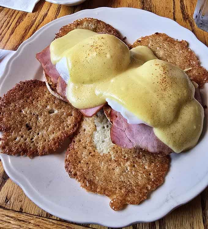 Eggs Benedict done right, with hollandaise that flows like liquid gold over perfectly poached eggs and crispy hash browns.