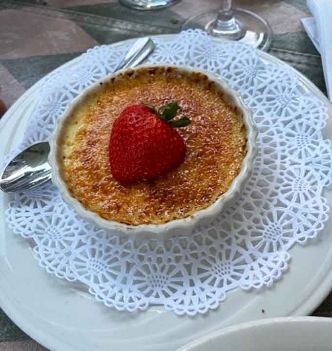Cr&egrave;me br&ucirc;l&eacute;e presented on lace, because sometimes dessert needs to dress up for the occasion too.
