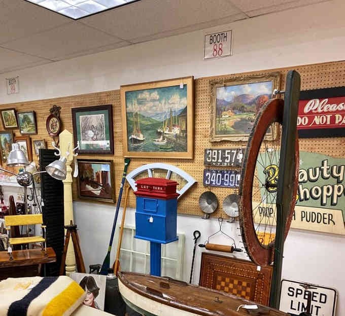 Sailboat paintings and vintage license plates create a visual symphony that somehow makes perfect nostalgic sense together.