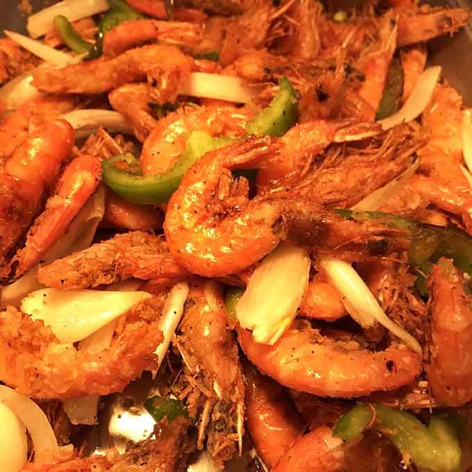 Shrimp piled high with peppers and onions, glistening with promise and making you forget every diet you ever considered starting.