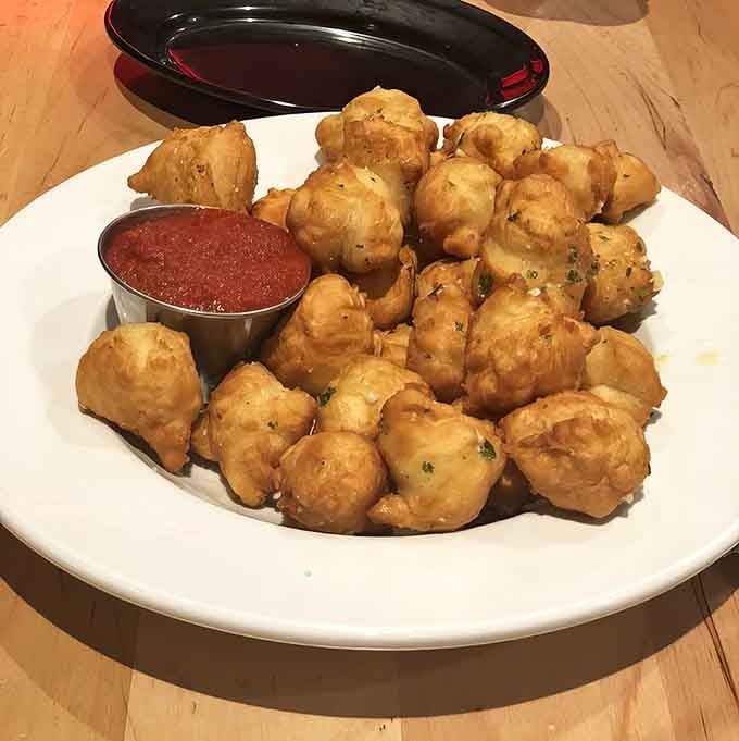 These golden garlic doughnuts are the appetizer that makes waiting for deep-dish pizza slightly more bearable.