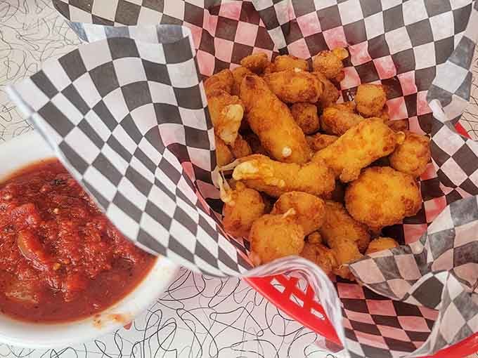 Golden cheese curds served in a checkered basket are Wisconsin's gift to humanity, and we're eternally grateful.