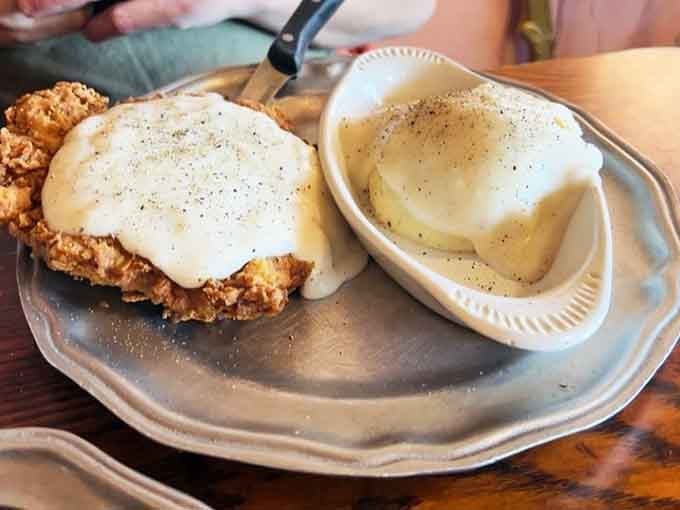 Country fried chicken with gravy that looks like it could solve most of life's problems, one crispy bite at a time.