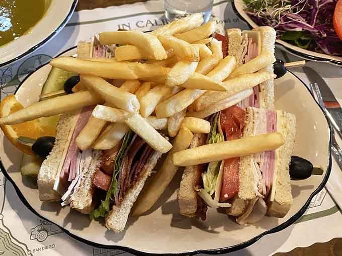 That club sandwich comes piled high with fries, perfect for folks who aren't ready to commit to pea soup.