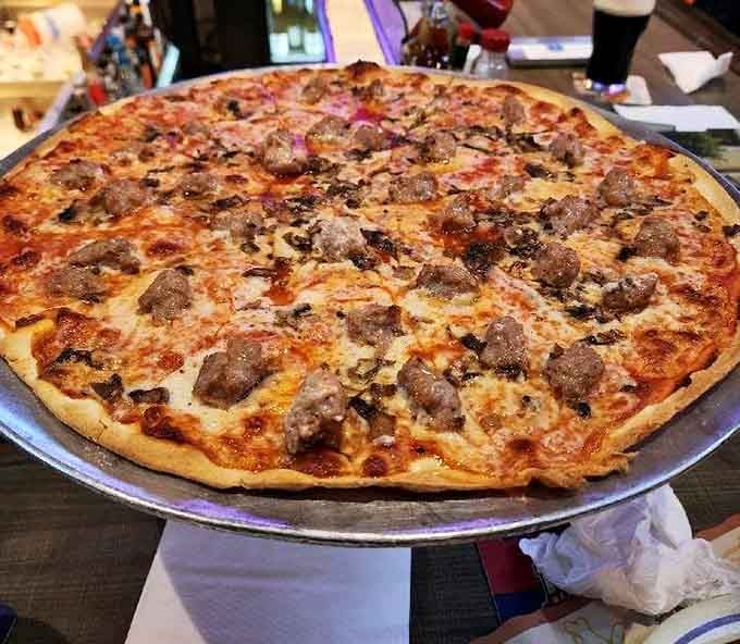 Sausage and mushrooms on that impossibly thin crust create a flavor combination that should probably be legally protected.