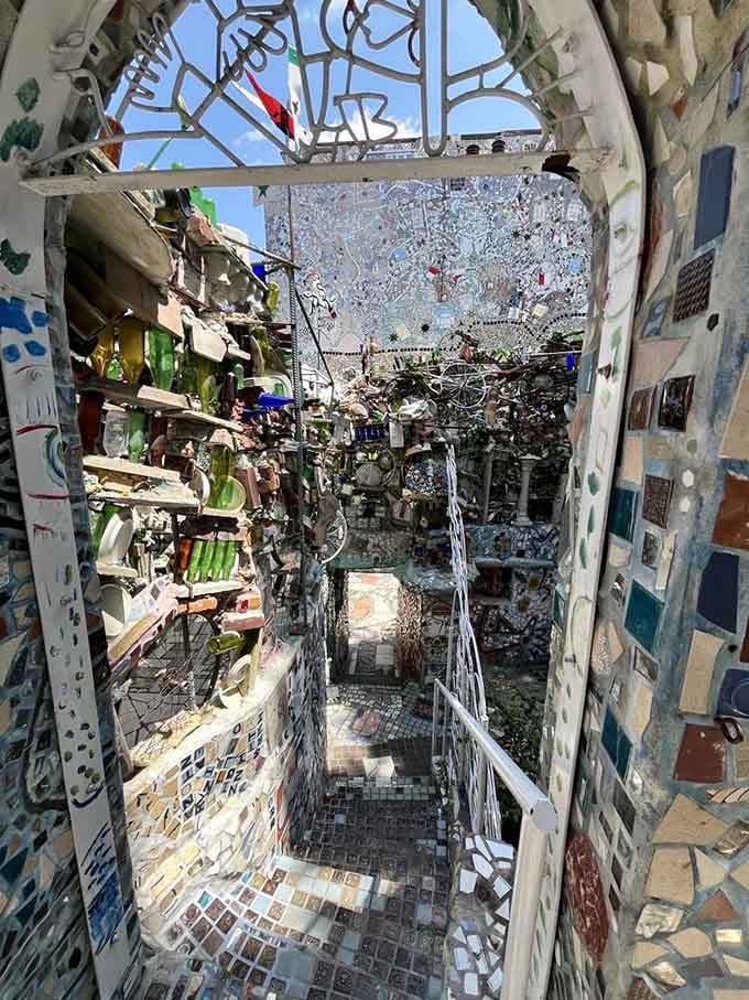 Sunlight streaming through the open-air passage reveals how bottles and tiles dance together in perfect chromatic harmony here.