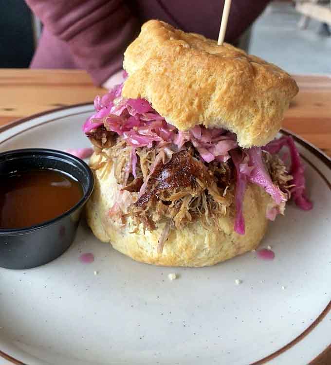 Pulled pork piled high on a biscuit with pickled slaw, proving Southern BBQ thrives in the Pacific Northwest.