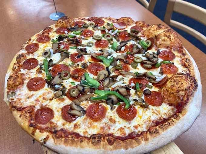 Half pepperoni, half veggie proves that compromise can be delicious when the pizza maker knows their craft this well.