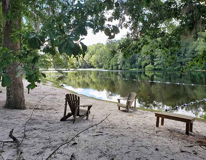 Adirondack chairs positioned perfectly for lakeside contemplation, because sometimes doing nothing is doing everything right.