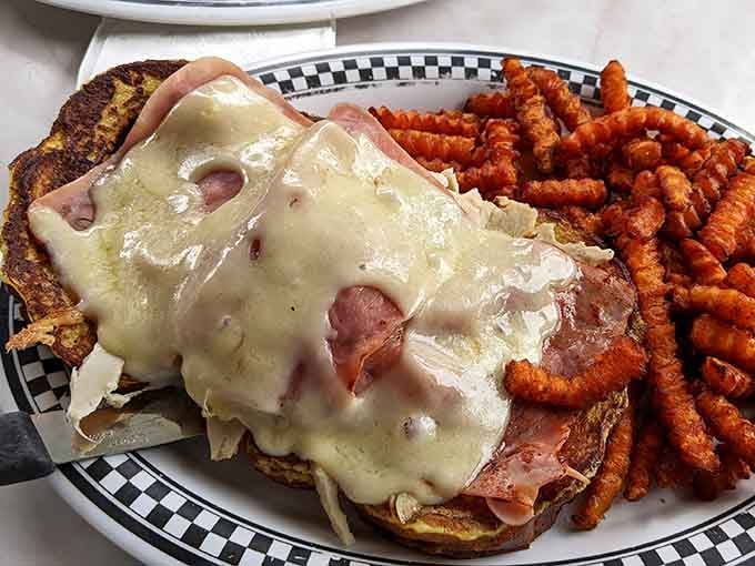The Monte Cristo arrives like a grilled cheese that went to finishing school, paired with sweet potato fries.