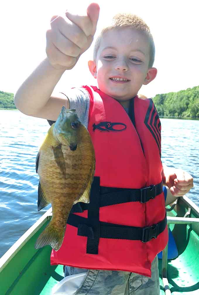 That smile says it all: catching your own dinner never gets old, no matter how young you are.