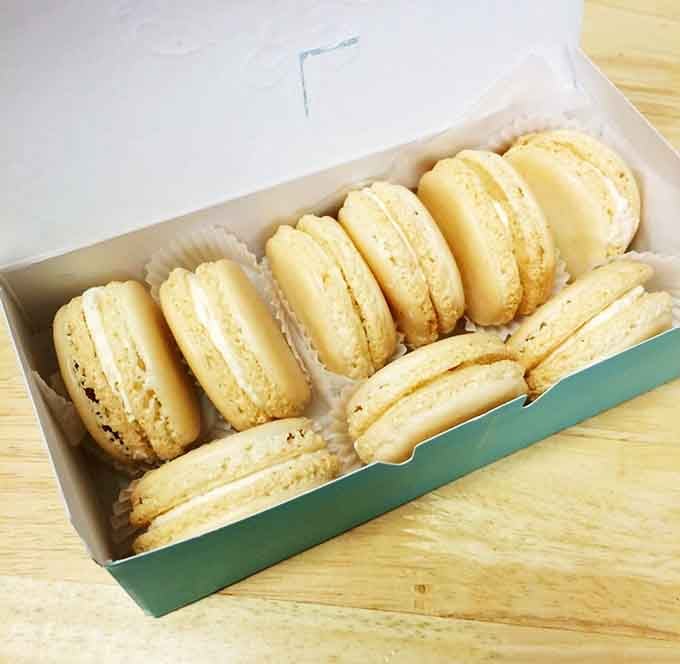 Delicate macarons lined up like pastel soldiers, each one a tiny masterpiece of almond meringue perfection.