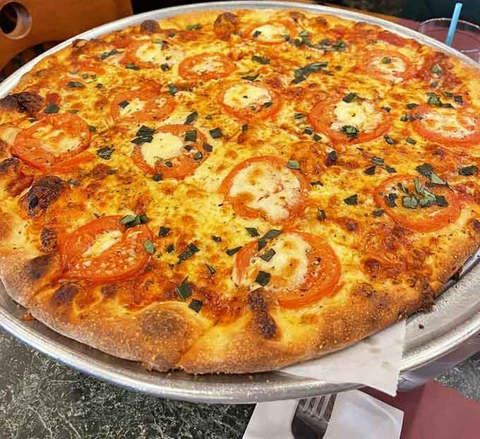 Fresh tomatoes and basil turn this Margherita into a simple masterpiece that lets quality ingredients shine through beautifully.