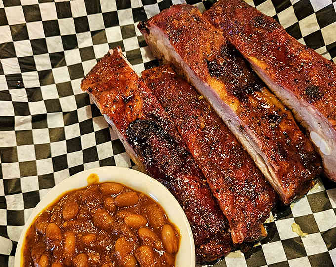 That mahogany bark on those ribs took hours of patient smoking, and one bite proves every minute was worth it.