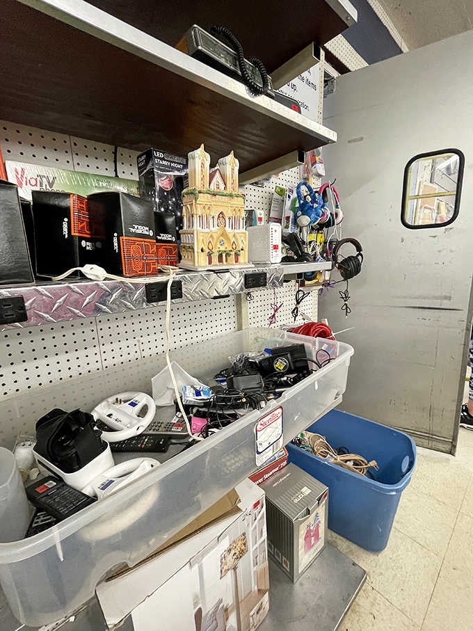 Eclectic finds create a visual treasure hunt where ceramic buildings meet modern electronics in perfect harmony.