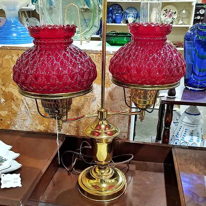 These ruby red hurricane lamps glow like they're holding secrets from elegant dinner parties of decades past.