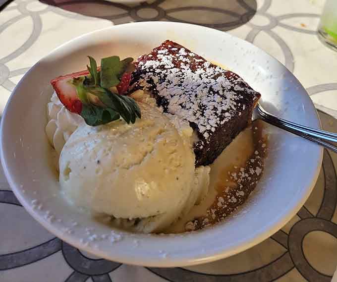 Chocolate cake with ice cream and powdered sugar, because sometimes dessert should require a nap afterward.
