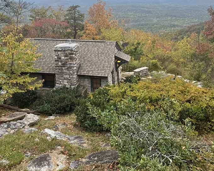 The historic stone cabin stands as a mountain sentinel, watching over valleys that stretch to forever.