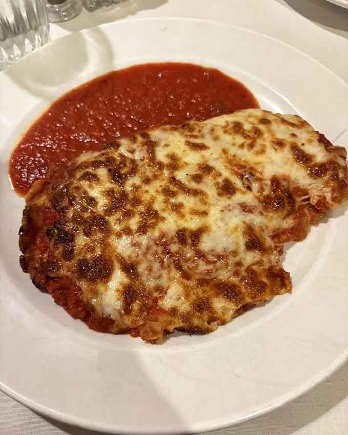 Chicken parmesan so generously portioned, it's practically spilling off the plate with cheesy, saucy glory.