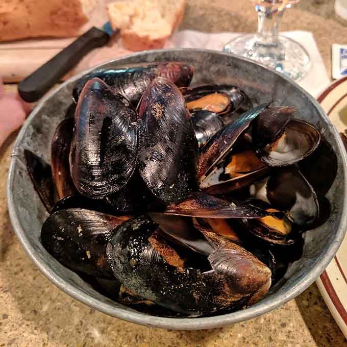 Steamed mussels arrive in their shells like little gifts from the sea, ready to transport you coastward.