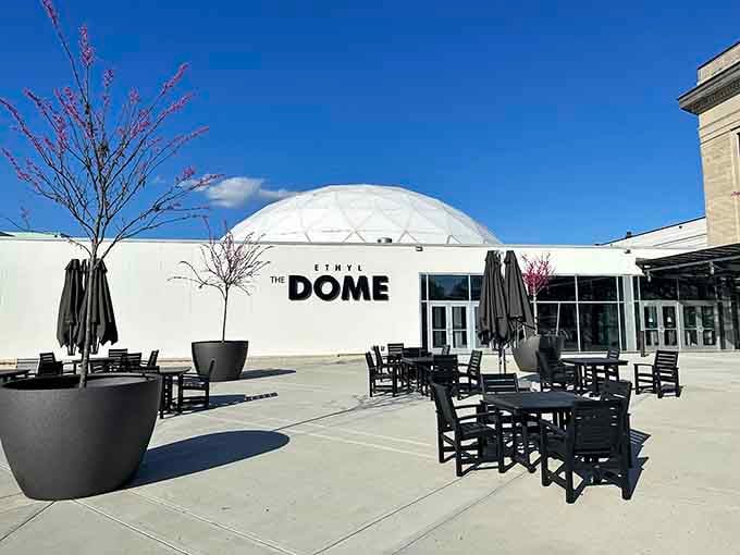 The Dome's exterior promises cosmic adventures, while those patio chairs offer earthbound contemplation with your coffee.