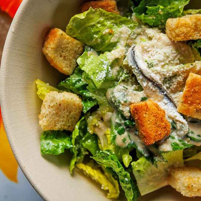 Caesar salad done right with generous parmesan shavings and crispy croutons that actually taste like real bread.